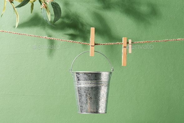 Gardening tools hanging on the rope, bucket on the natural green ...