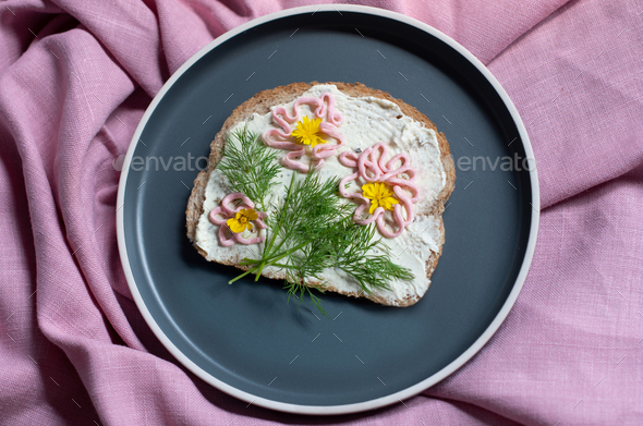 creative sandwich with soft cheese and pink pasta tarama greens ...