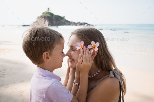 Happy mother and son at the beach in summer Stock Photo by natanavo