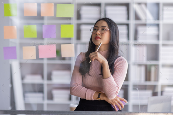 Young Asian woman Creative team use post it notes to share idea sticky ...