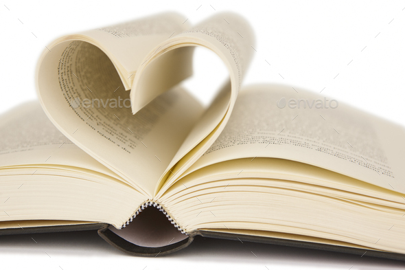 Open book with heart shaped pages. Love for reading Stock Photo by ABBPhoto