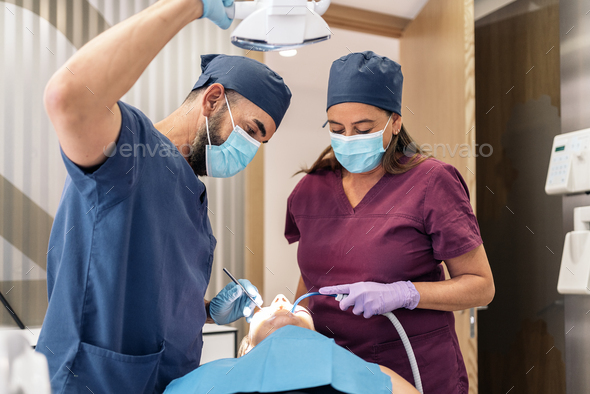 Dental Clinic Workers with a Patient Stock Photo by nunezimage | PhotoDune