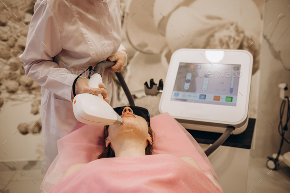 Beautiful woman having her facial hair removed by female beautician ...