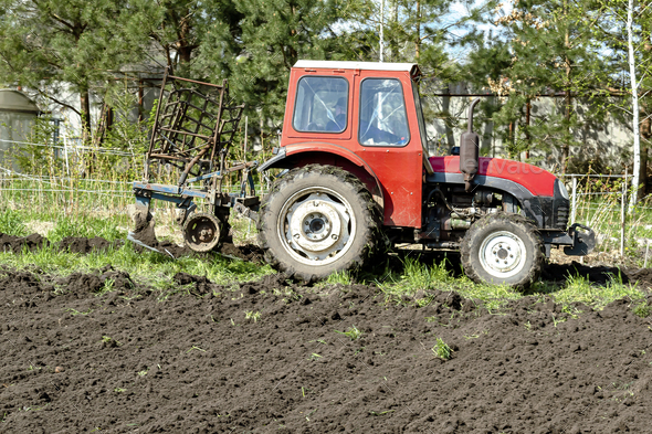 tractor plowing agricultural field meadow at farm cultivating make soil ...