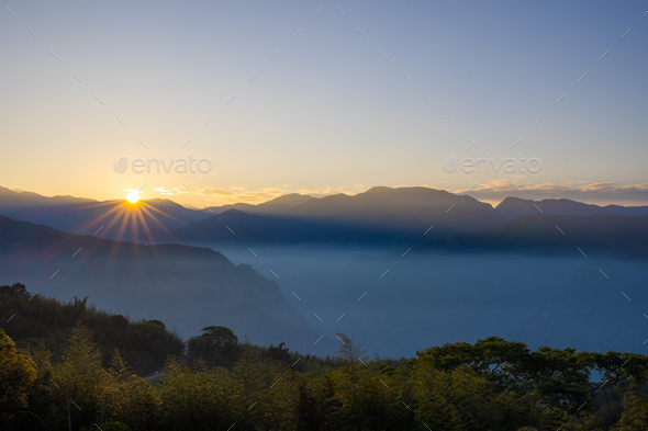 Chiayi alishan sunrise in alishan national park Stock Photo by leungchopan