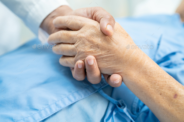 Holding hands Asian senior woman patient with love, care, encourage and empathy at nursing ...