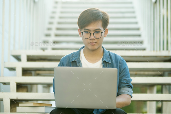 Student studying outdoor using laptop. Stock Photo by ijeab | PhotoDune