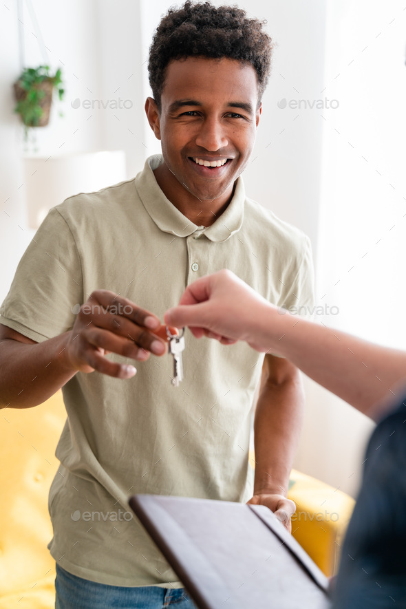 Cheerful black man receiving his new house keys Stock Photo by ...