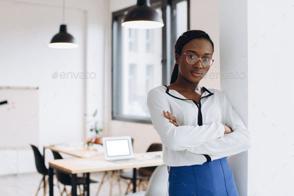 Portrait of a young African American business woman in modern loft ...