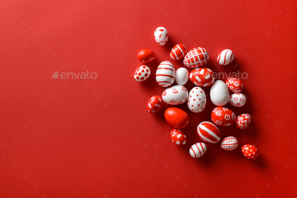 Easter backgrounds, scattered Easter red and white eggs on a bright red ...