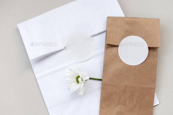 Round sticker mockup on gift white and kraft package, envelope with ...
