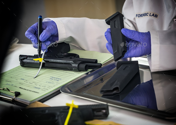 Police scientist notes serial number on sealed firearm in crime lab ...