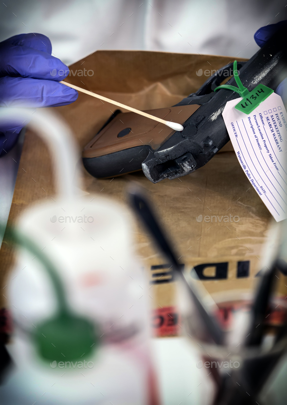 Police scientist analyzes gunpowder evidence with isopo in crime lab ...