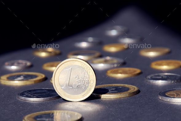 Euro coin standing on edge shining in spotlight. Money flow Stock Photo ...