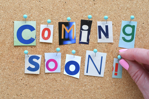Person pinning a Coming Soon notice to a cork bulletin board. Stock ...