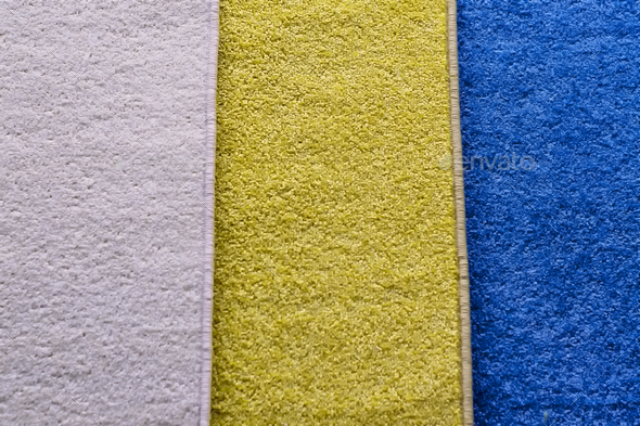 Textile pile mats of different colors. Front view, indoors horizontal ...