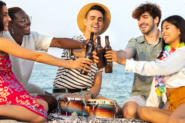 Cheers. Smiling friends enjoy cold beer at the beach. Diverse people ...