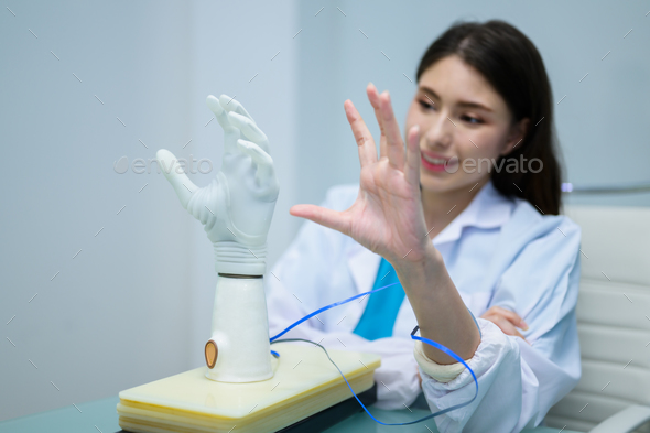Technician testing robotic bionic arm at prosthetic manufacturing Stock ...
