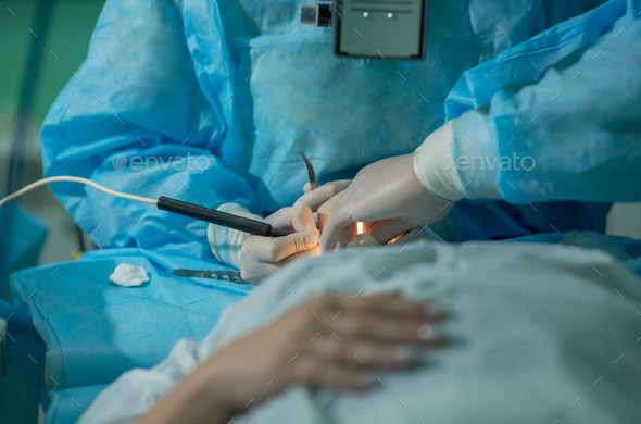 woman ophthalmologist performs an operation on the patient's eye. Stock ...