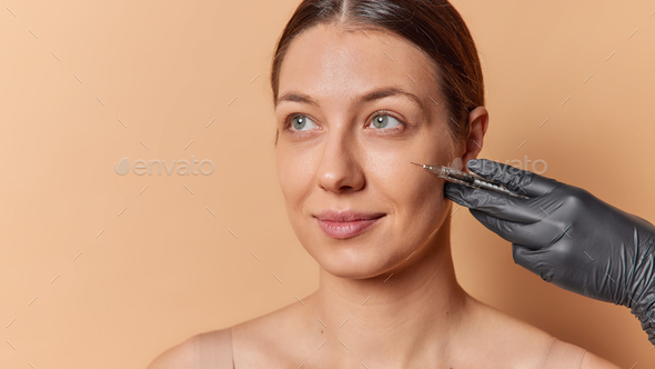 Indoor shot of blue eyed woman with dark combed hair gets intraocular ...