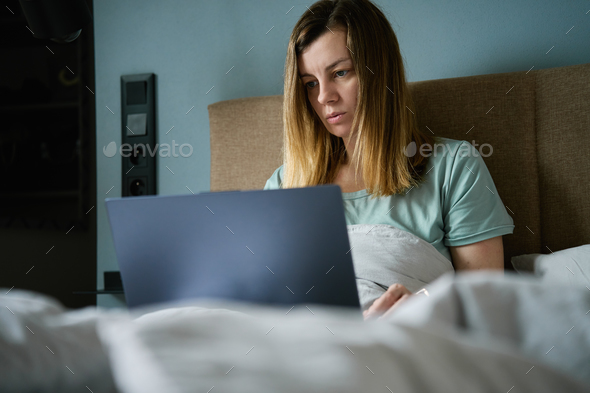 Woman lying in bed and using laptop Stock Photo by Lazy_Bear | PhotoDune