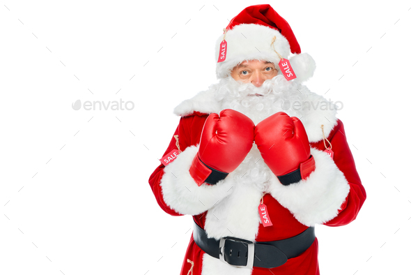 serious santa claus in boxing gloves and red costume with sale tags ...