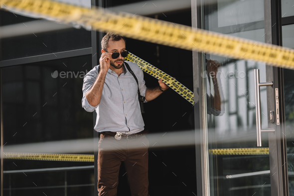 Male Detective Straightening Sunglasses Holding On The Cross Line Stock