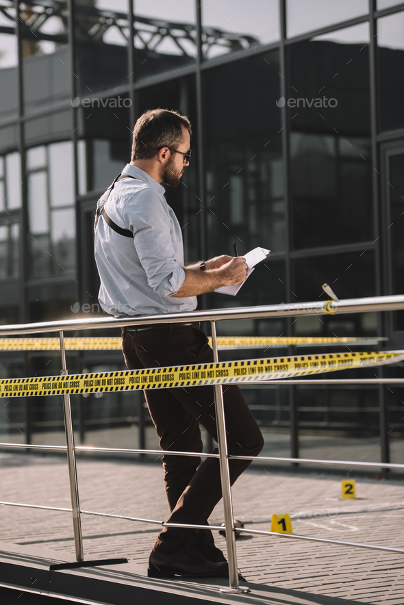 back view of male detective in sunglasses making notes Stock Photo by ...