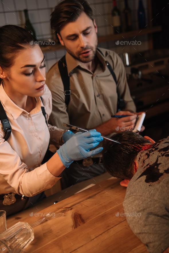 Cropped View Of Concentated Female And Male Detectives Collecting