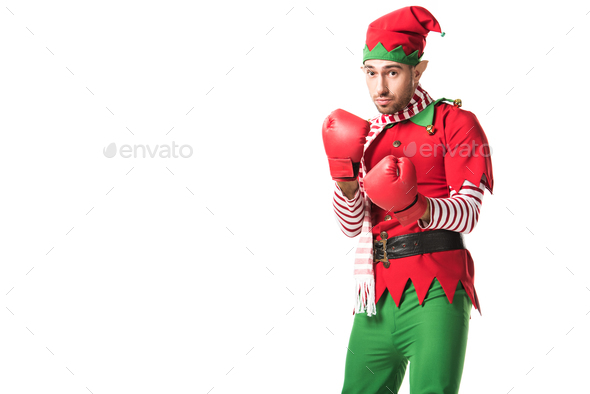 focused man in christmas elf costume wearing red boxing gloves and ...