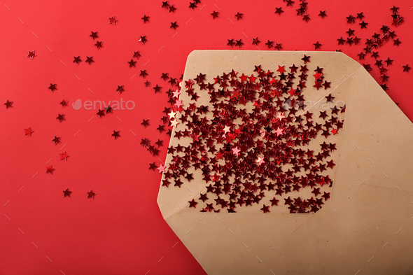Envelope from craft paper on the red background with glitter shiny ...