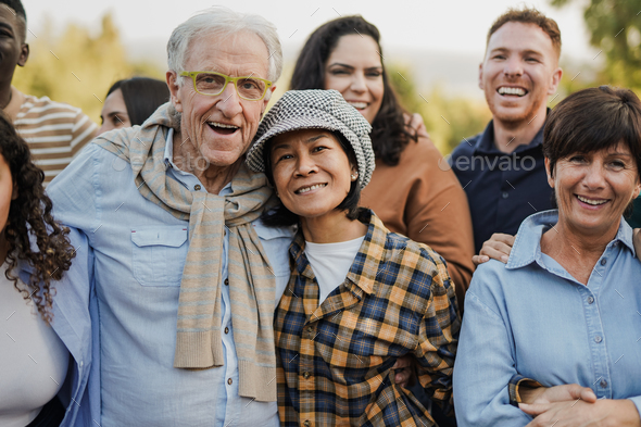 Group of multi generational people having fun together at city park ...