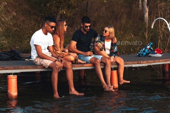 Group of friends enjoying a day at the lake. Stock Photo by zoranzeremski