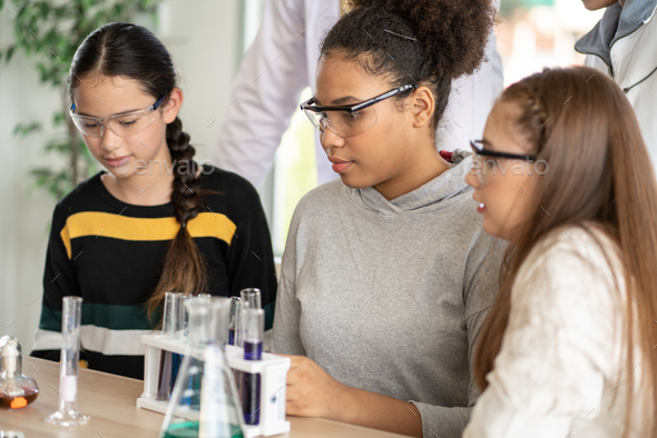 Students in science class doing chemical experiment in laboratory Stock ...