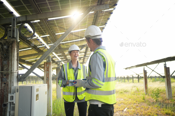 At construction site, Engineer servicing solar panel on electric plant ...
