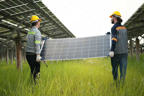 At construction site, Engineer servicing solar panel on electric plant ...