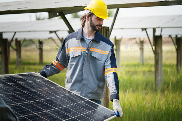 At construction site, Engineer servicing solar panel on electric plant ...