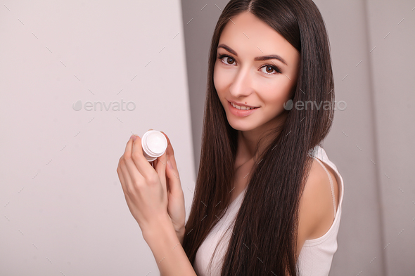 Woman with clean fresh skin touch face . Facial treatment , cosmetology ...