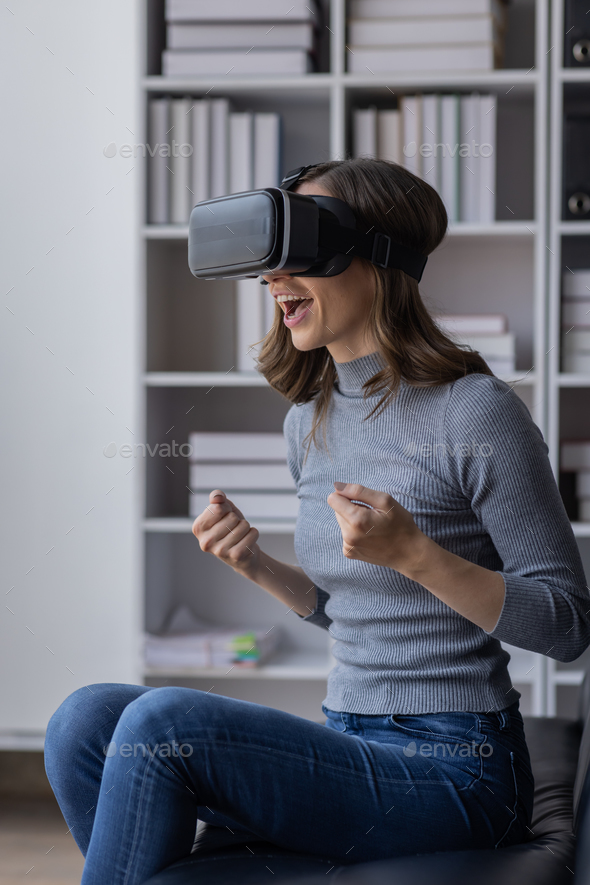 Surprised Young latin woman in VR headset touching air, Smiling white woman wearing vr glasses ...