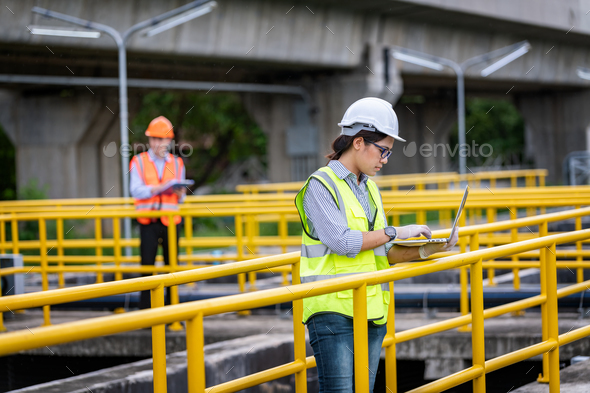 Engineer take water from wastewater treatment pond to check the quality ...
