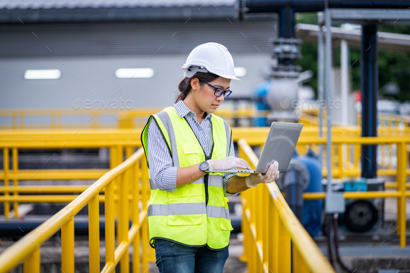 Engineer take water from wastewater treatment pond to check the quality ...