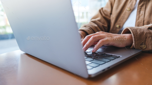 Closeup image of hands working and typing on laptop computer keyboard ...
