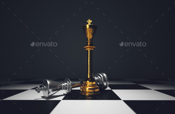 Golden chess king standing over the fallen silver king on a chess board ...