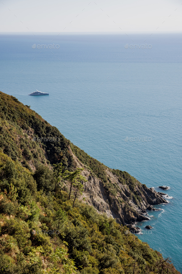 The rocky terrain and turbulent waves create a dynamic contrast Stock ...