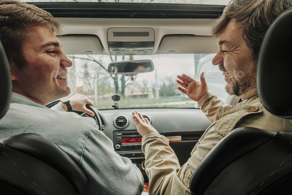 father and son have a discussion inside the car Stock Photo by Masson-Simon