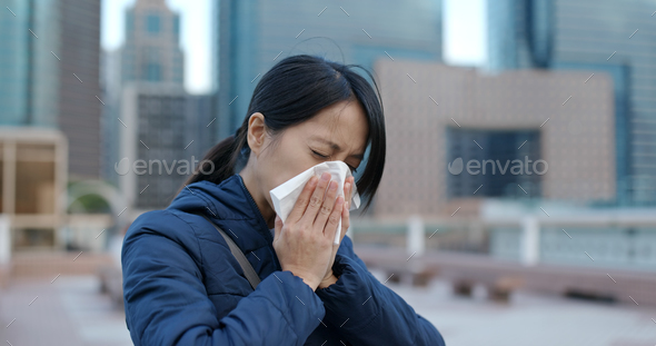Sick woman sneezing at outdoor Stock Photo by leungchopan | PhotoDune