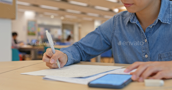 Woman write on the paper at library Stock Photo by leungchopan | PhotoDune