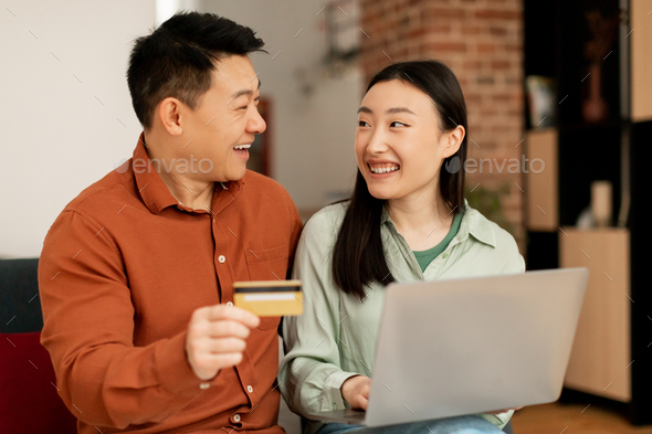 E-commerce, internet banking. Happy asian couple shopping online with ...