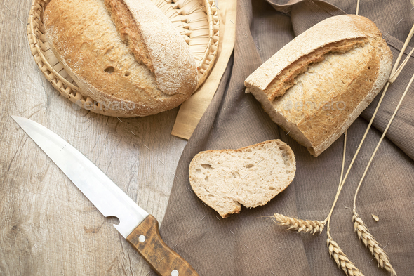fresh bread cutted slice of baguette with knife and copy space, baked ...