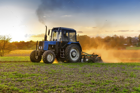 blue tractor machinery plowing agricultural field cultivating,soil ...